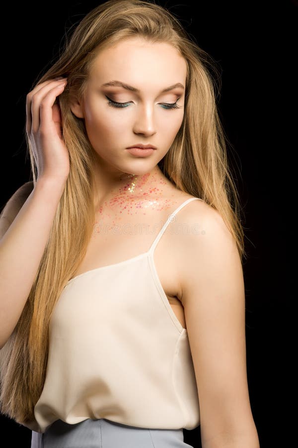 Lovely Young Model with Glitter on Her Neck in Dark Studio Stock Photo ...