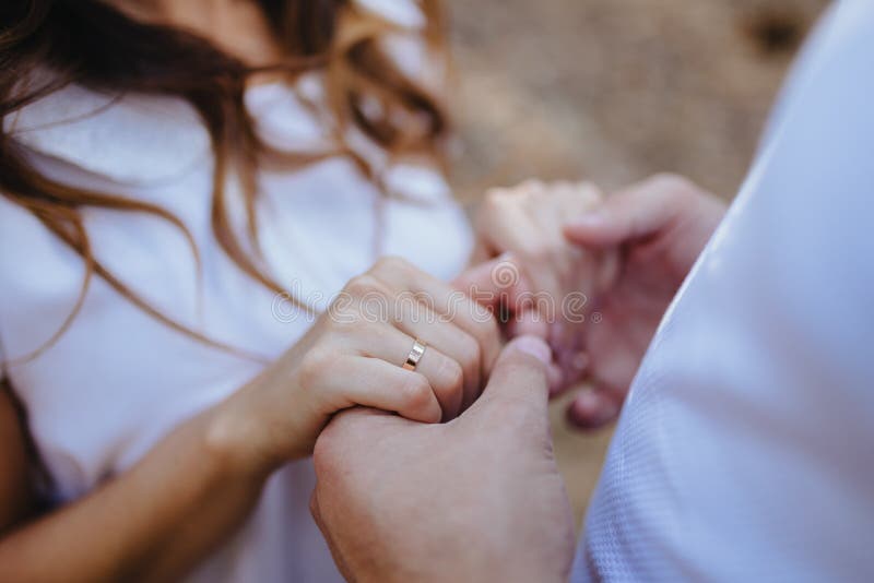 Lovers Holding Hands with Gold Wedding Rings. Bride and Groom. Stock ...