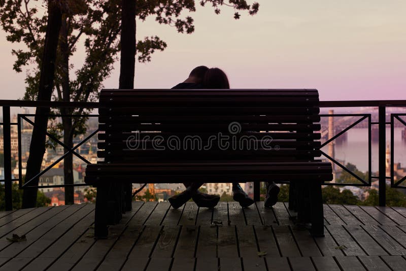 Lovers Sit on a Bench in Front of a Beautiful View of the City Stock ...