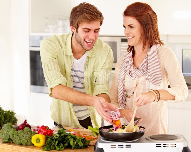 He really Loves Cooking. a Young Couple Cooking in the Kitchen. Stock ...