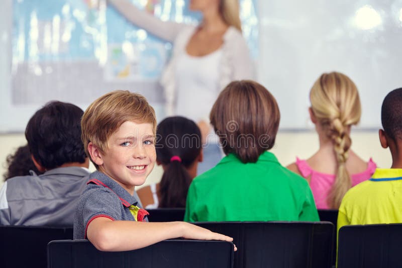 He Loves Learning. Portrait of a Little Boy Sitting with His Classmates ...
