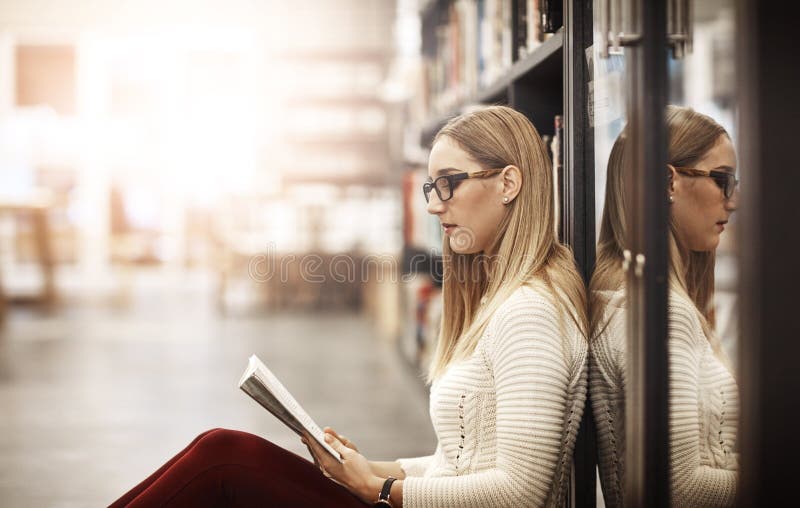 She Loves Learning. a University Student Reading a Book in the Library ...