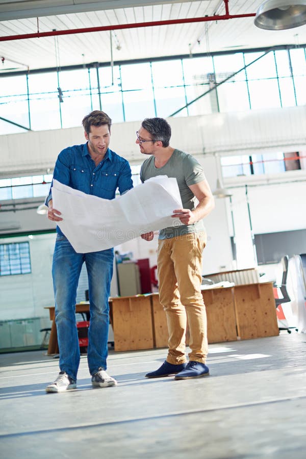 He Loves the Planning Phase. Two Architects Looking at Blueprints ...