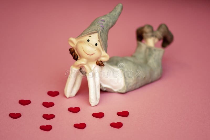 Loving Boy Elf Ceramic with Hearts on Coral Background Stock Image ...