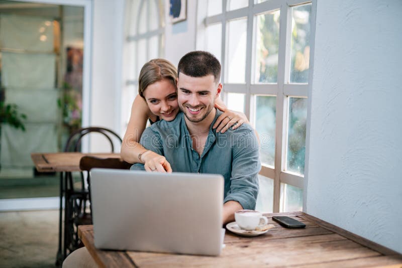 Loving Couple Hugging and Looking at Laptop. the Concept of Couples ...