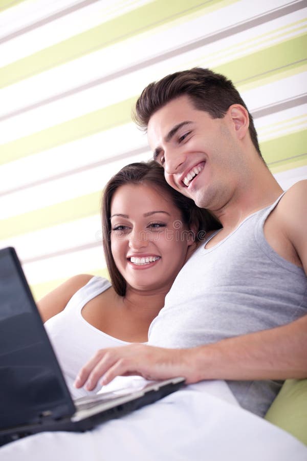 Loving couple with laptop stock photo. Image of enjoy - 30949750