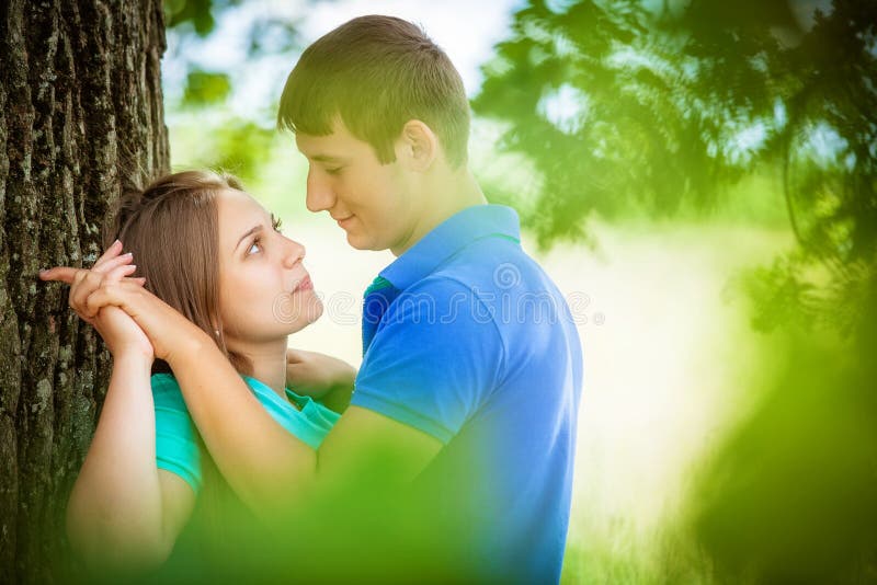 Loving couple near a tree stock photo. Image of attractive - 43160498