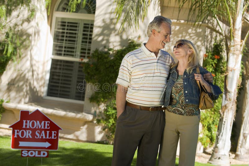 Retired Senior Couple in Front of Sold Real Estate Stock Image - Image ...