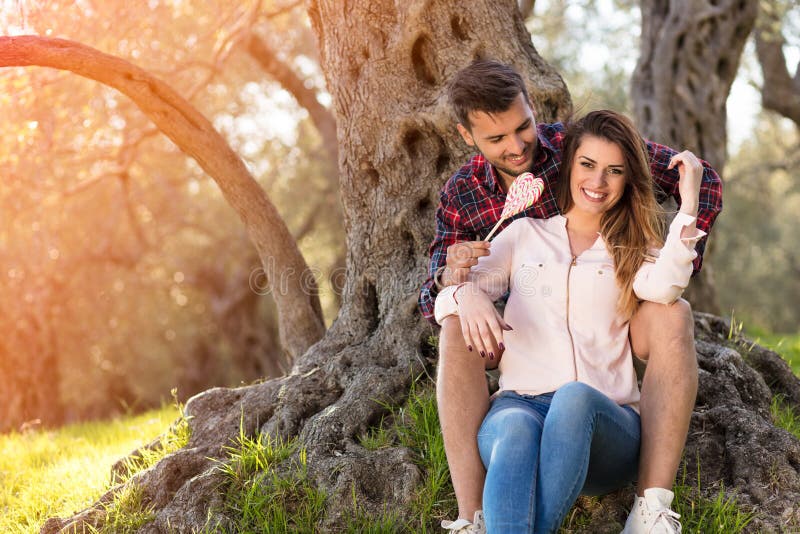 Loving Couple Under a Big Tree in the Park in Autumn Stock Photo ...