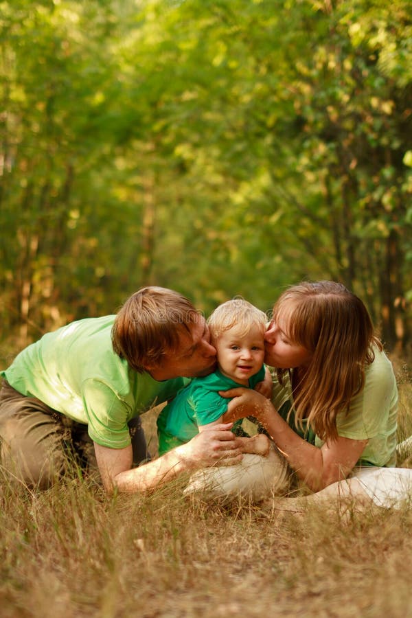 Loving family kiss stock image. Image of forest, parenting - 22217533