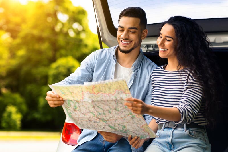 Loving Middle-eastern Couple Watching Map while Having Break Stock ...