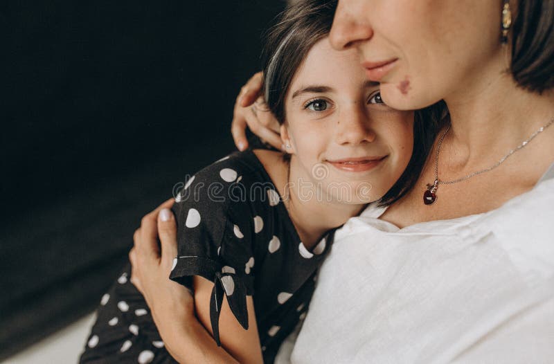 Loving Mother And Daughter Gently Hug Each Other They Smile And Enjoy