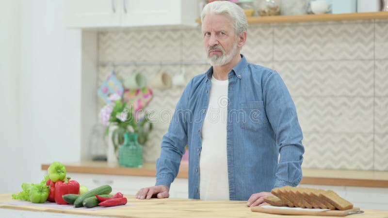 Loving Old Man Shaking Head As No Sign while in Kitchen Stock Image ...