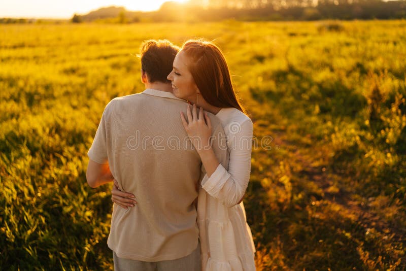 Loving Unrecognizable Young Man And Redhead Woman In Love Hugging