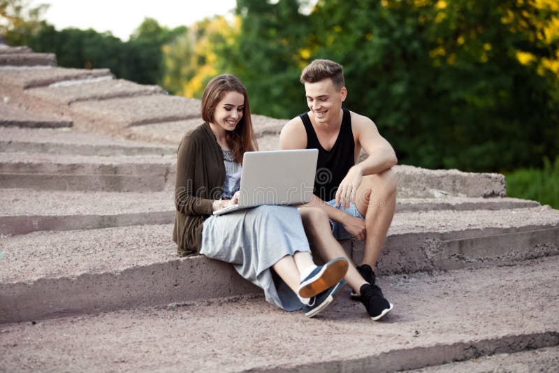 Loving Young Couple Sitting on a Walk with Laptop Stock Image - Image ...