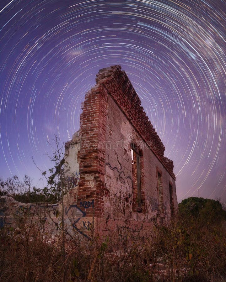 Low-angle of an Abandoned Building Ruins with Night Star Trails in the ...