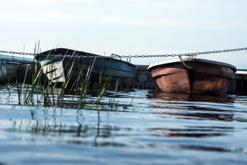 Low Angle of Anchored Boats Chained on a Lake Stock Image - Image of blue, chain: 262716703