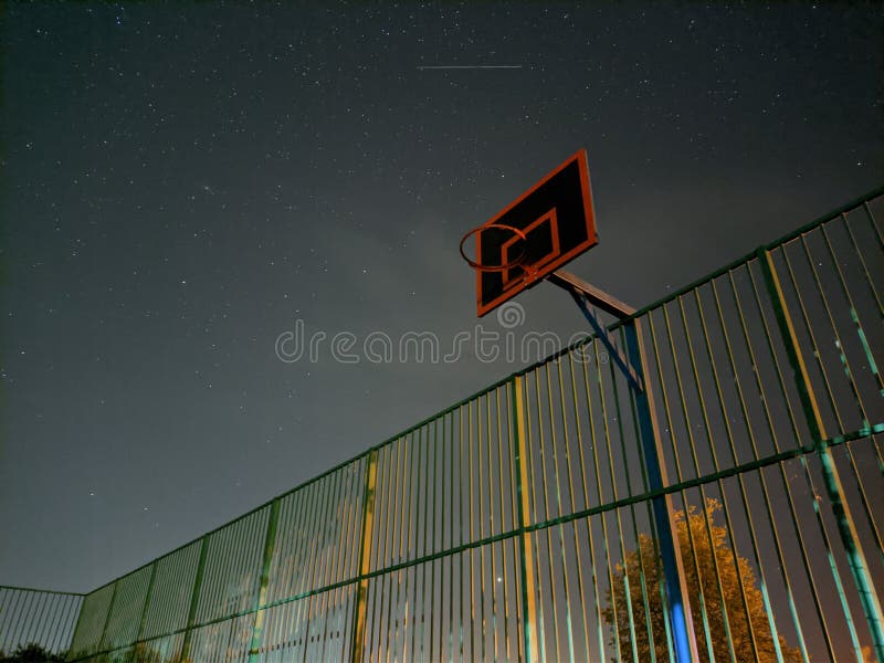 Low-angle of a Basketball Net Outdoors with a Starry Night Sky in the ...