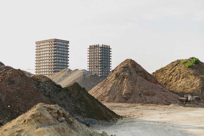 Low-angle of Building in a Construction Place with Sand Piles Gloomy ...