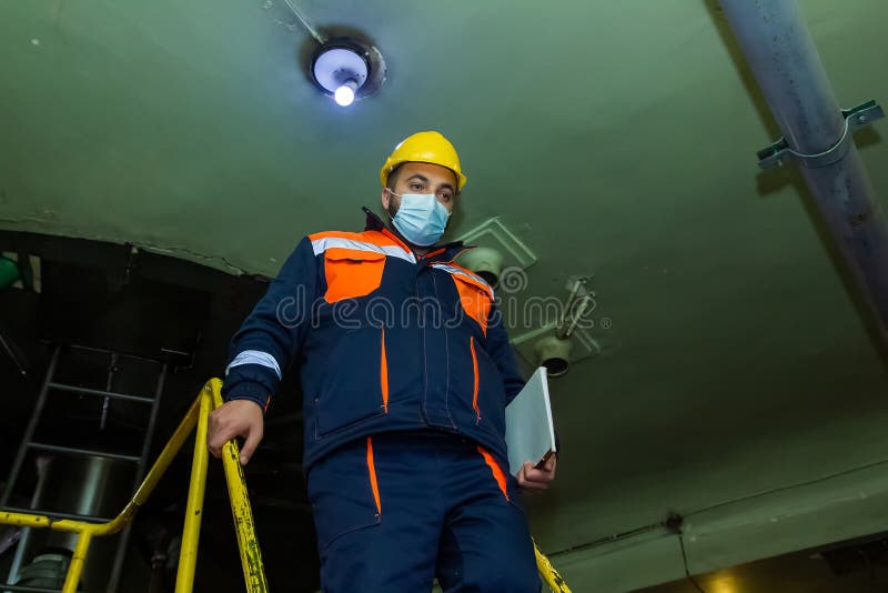 Low Angle of a Caucasian Mechanical Engineer Holding a Notebook in ...