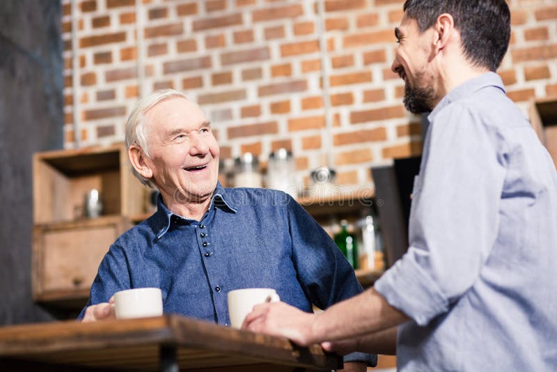 Low Angle of Cheerful Aged Mna Talking with His Son Stock Photo - Image ...