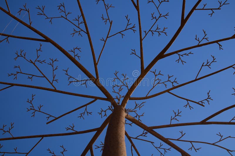Low Angle Close Up of a Rusty Metal Tree with a Blue Sky in the ...