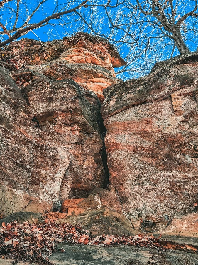 Low-angle Closeup of Various Rock Formations and a Cave with Writing in ...