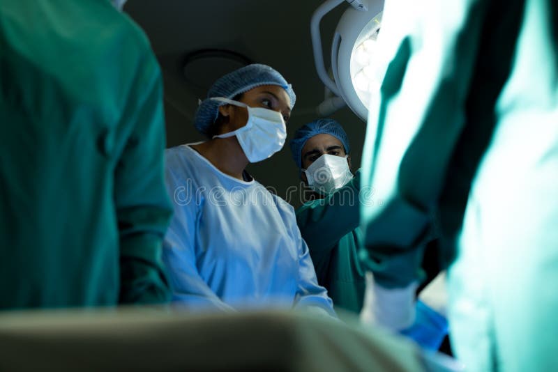 Low Angle of Diverse Surgeons Discussing during Operation in Operating ...