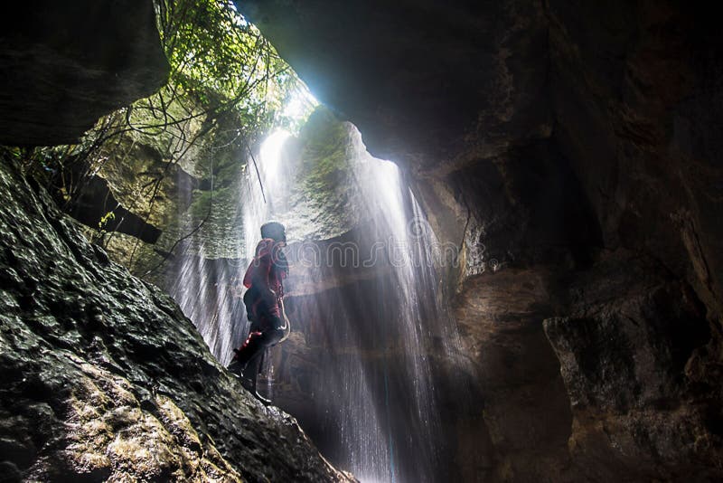 Low-angle of a Female Standing in the Cave and Light Coming from the ...