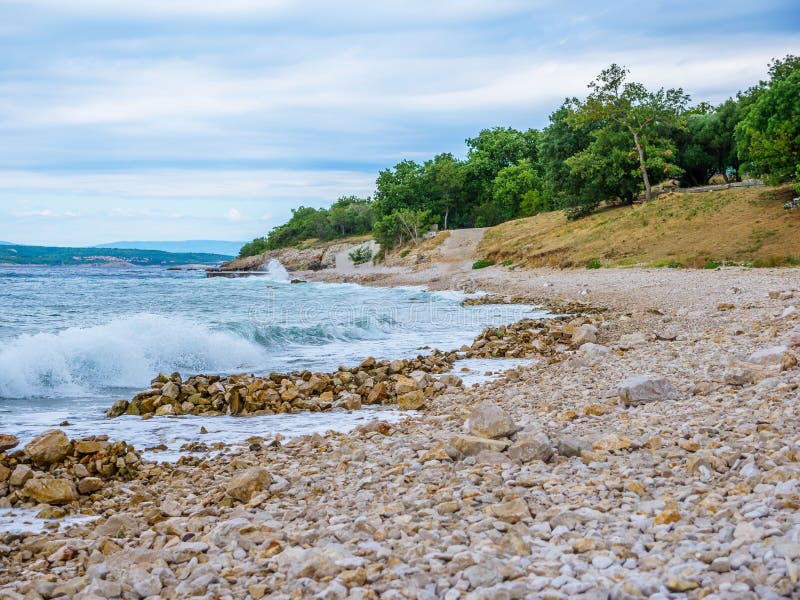 Low Angle of Foamy Waves Approaching the Rocky Beach Stock Image ...