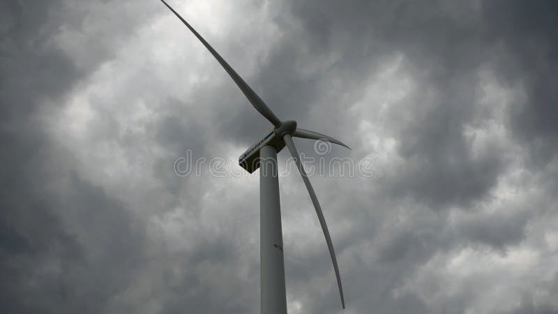 Low Angle Footage of a Wind Turbine Under a Stormy Gray Cloudy Sky ...