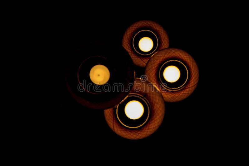 Low Angle of Four Lamps with a Dark Background. Stock Image - Image of ...