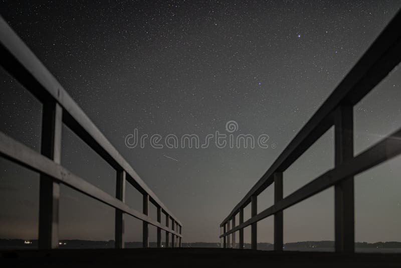 Low-angle Grayscale of a Fenced Pathway Under the Starry Night Sky ...
