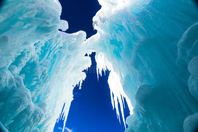 Low Angle of Huge Ice Formations with Hanging Icicles Against the Blue ...