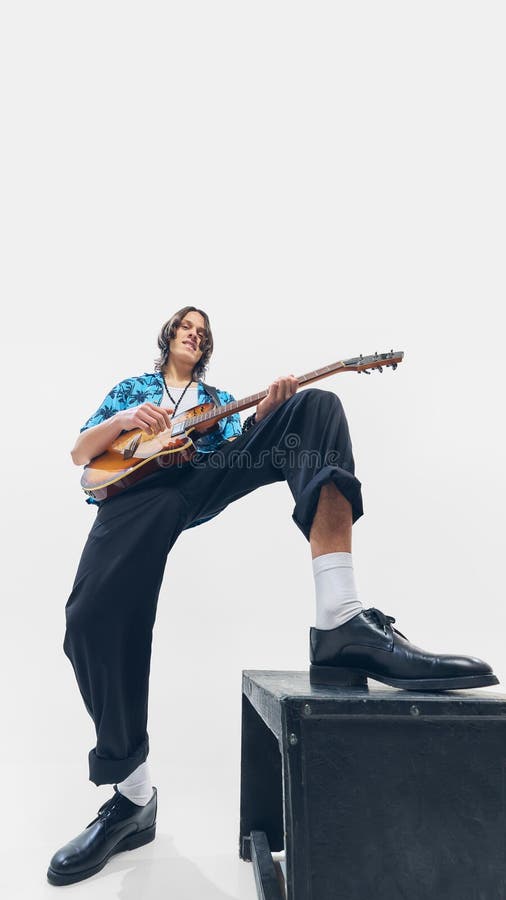 Low-angle Image of Energetic Young Man, Confidently Playing Electric ...