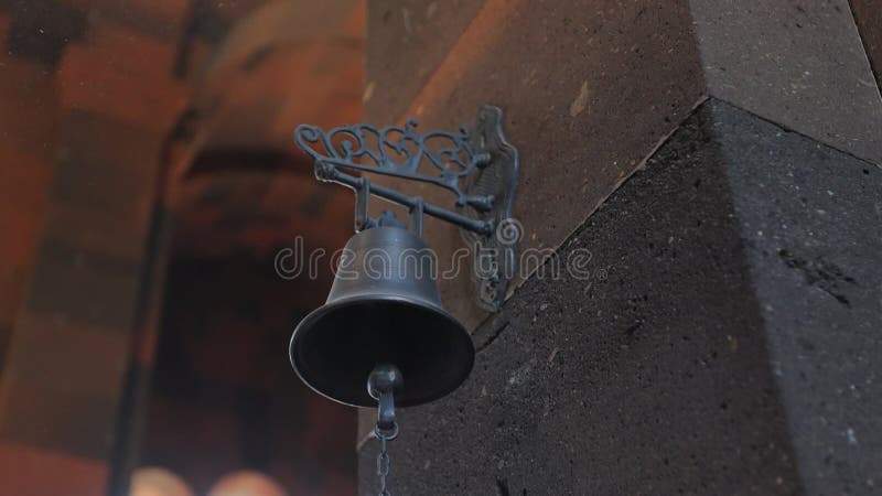 Low Angle of Metal Bell Handing on Granite Pillar in a Historic ...