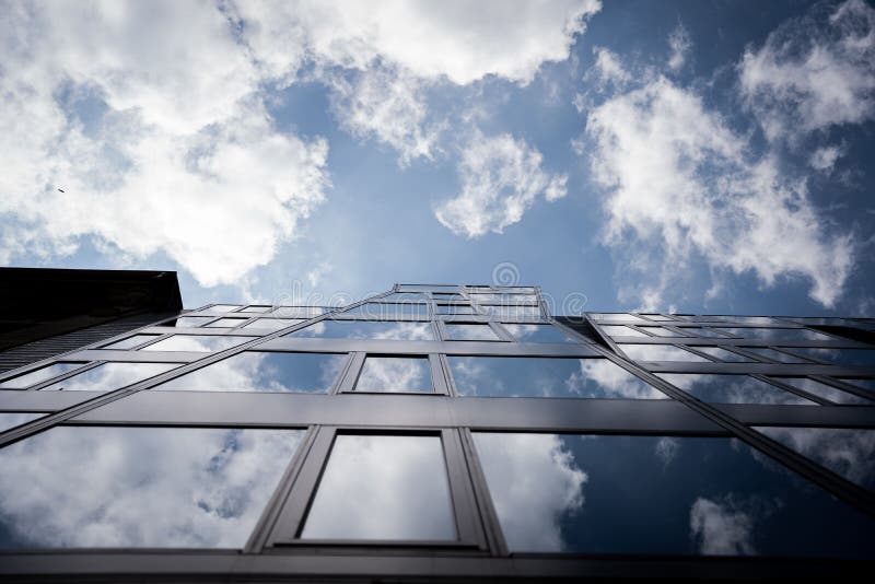 Low Angle of a Modern Glass-walled Building with a Reflection of Sky ...