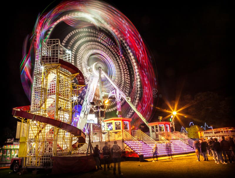 Low Angle Motion Blur of a Turning Ferries Wheel with the Lights on in ...
