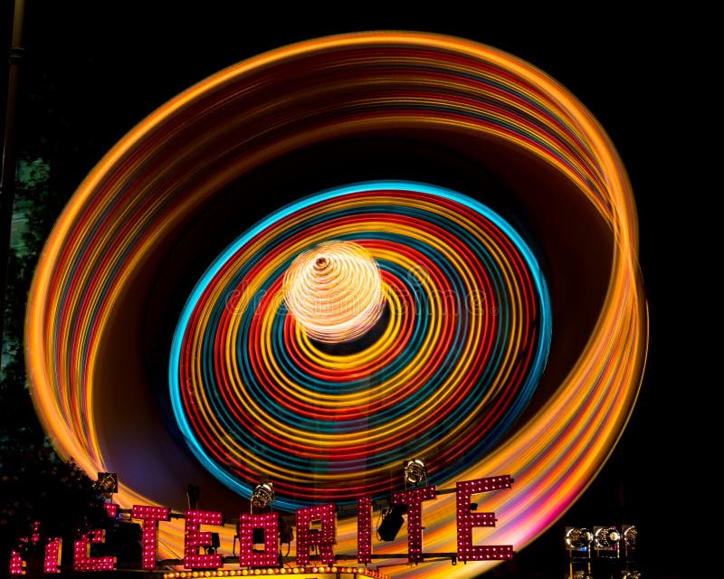 Low Angle Motion Blur of a Turning Ferries Wheel with the Lights on in ...