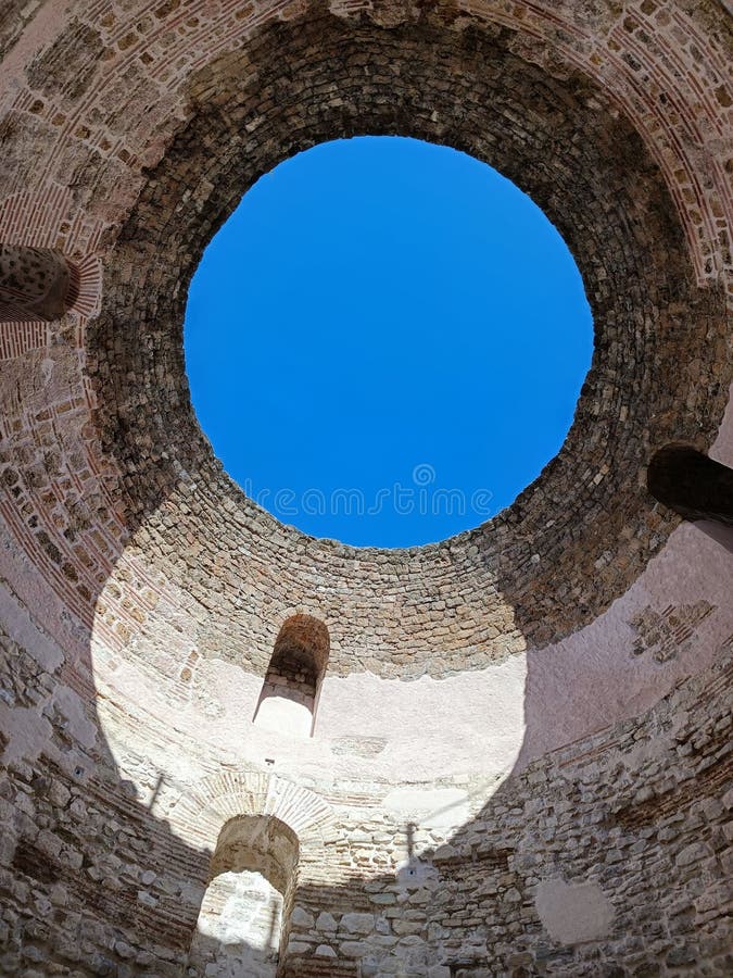 Low Angle of an Old Ancient Tower Against a Bright Blue Sky in a Round ...