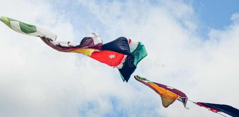 Low Angle Panoramic Shot of Various Flags Hung on a Wire Under the ...