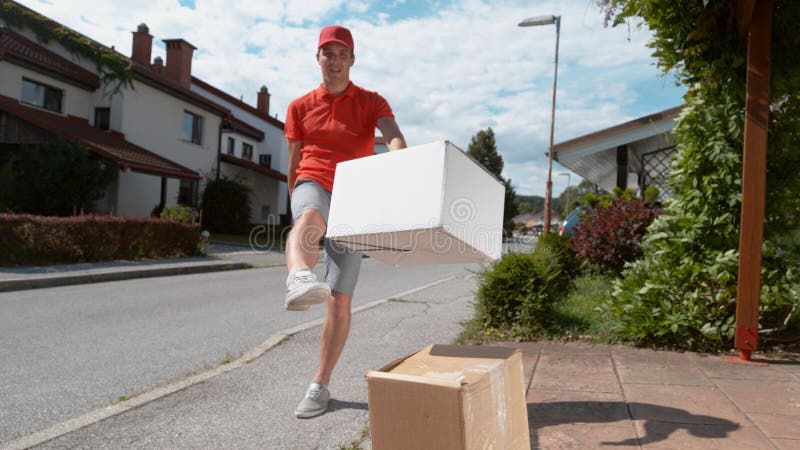 LOW ANGLE: Parcel Delivery Guy Drop Kicks a Package into Someone S ...