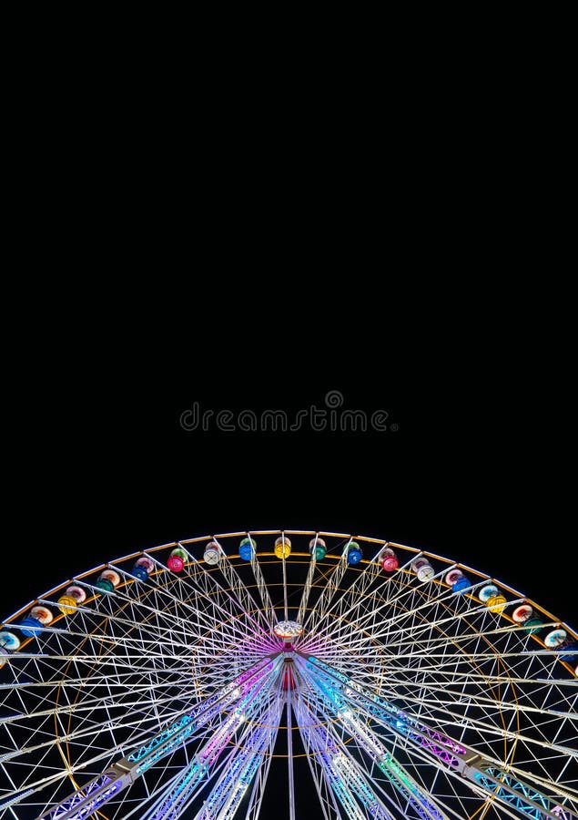 Low Angle Partial View from Below of a Ferris Wheel Illuminated with ...