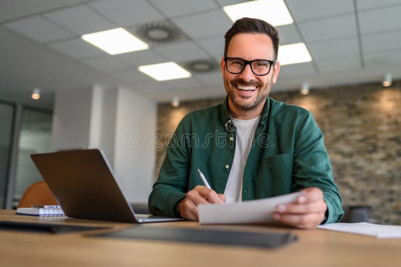 Low Angle Portrait of Financial Advisor in Eyeglasses Signing Documents ...