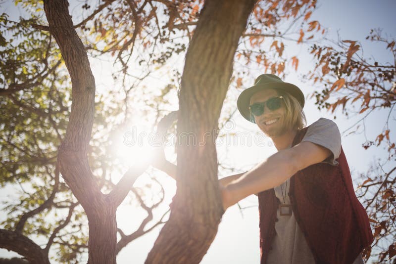 Low Angle Portrait of Smiling Man Standing on Tree Stock Photo - Image ...