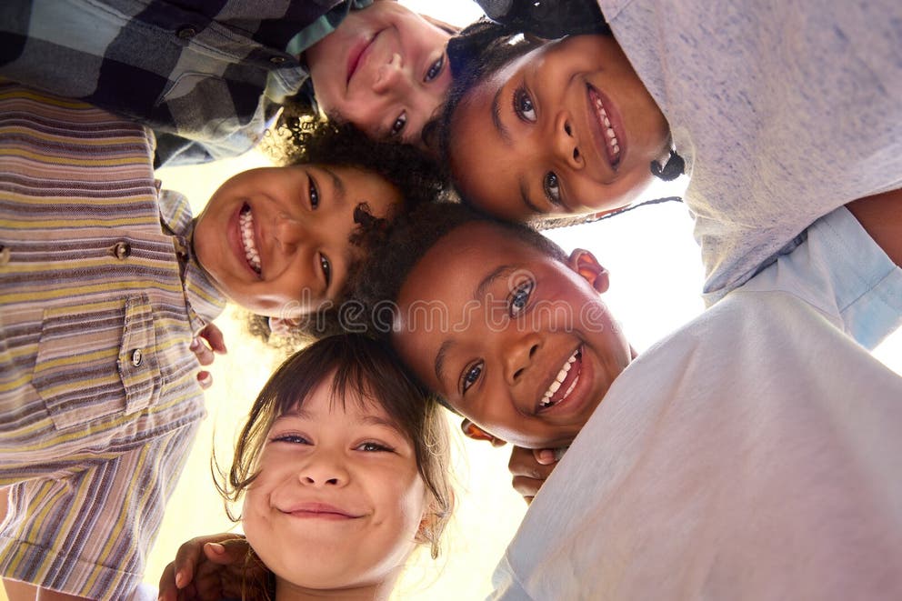 Low Angle Portrait of Smiling Multi-Cultural Children Looking Down into ...