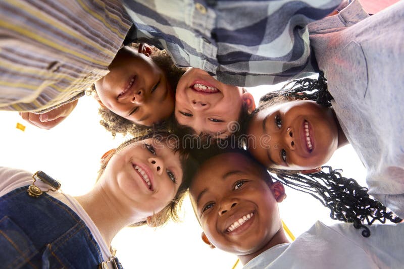 Low Angle Portrait of Smiling Multi-Cultural Children Looking Down into ...