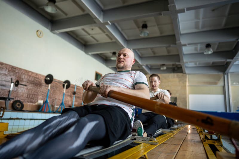 Determined Rowers Sports Training, Puddling on Rowing Simulator in Pool ...