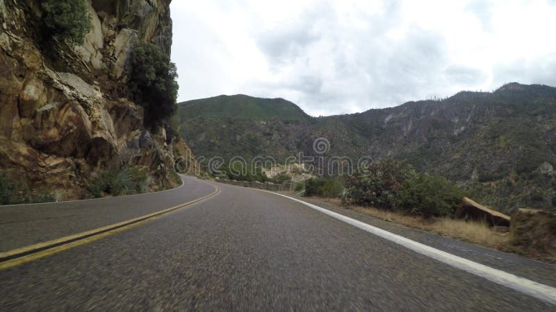 Low Angle of Road with Tall Rock Wall on Left and Cliff on Right Stock ...