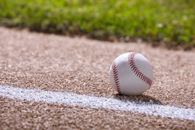 Low Angle Selective Focus View of a Baseball on a Basepath in Sunlight ...